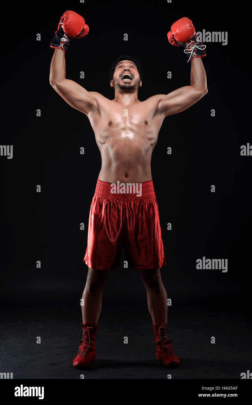 Portrait of asian guy boxer is celebrating his winning over black ...