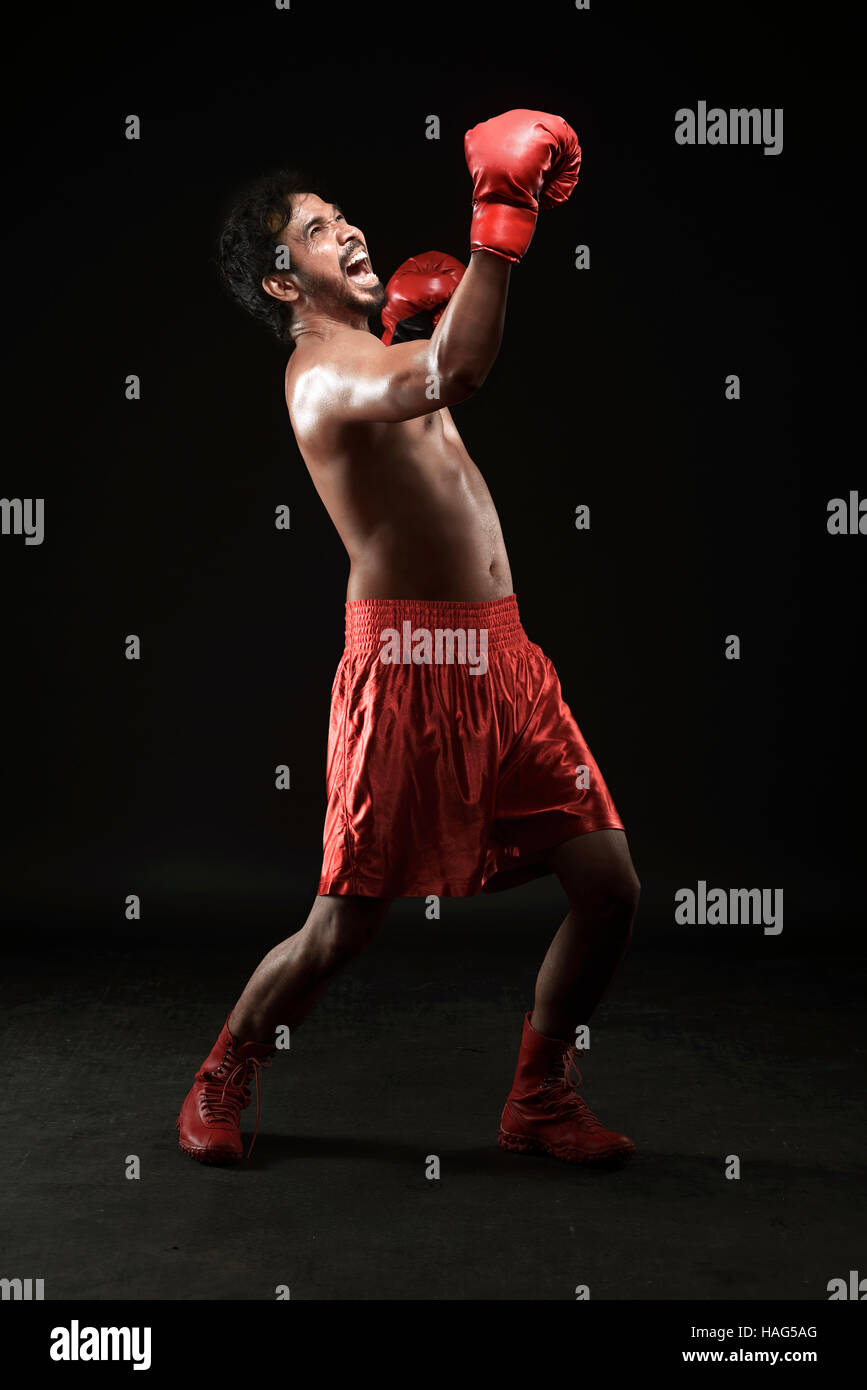 Portrait of asian guy boxer is celebrating his winning over black ...