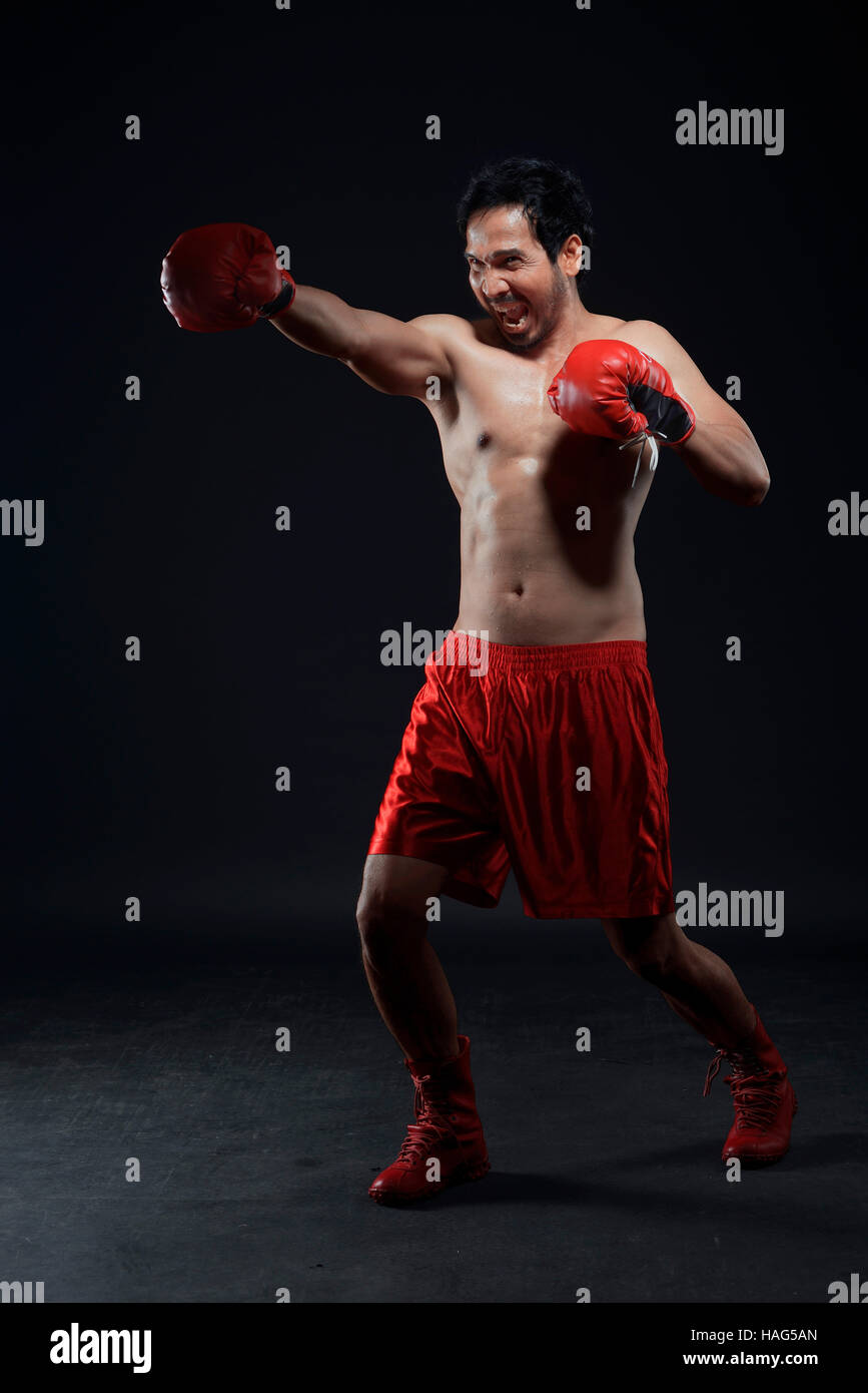 Asian male boxer expressions with gloves on punch training Stock Photo ...