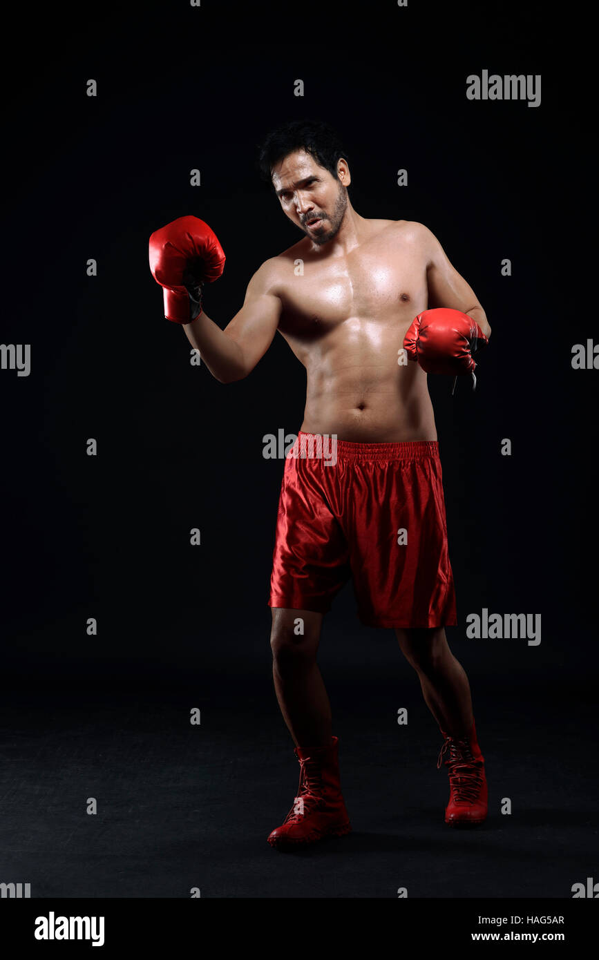 Portrait of asian guy boxer is celebrating his winning over black ...