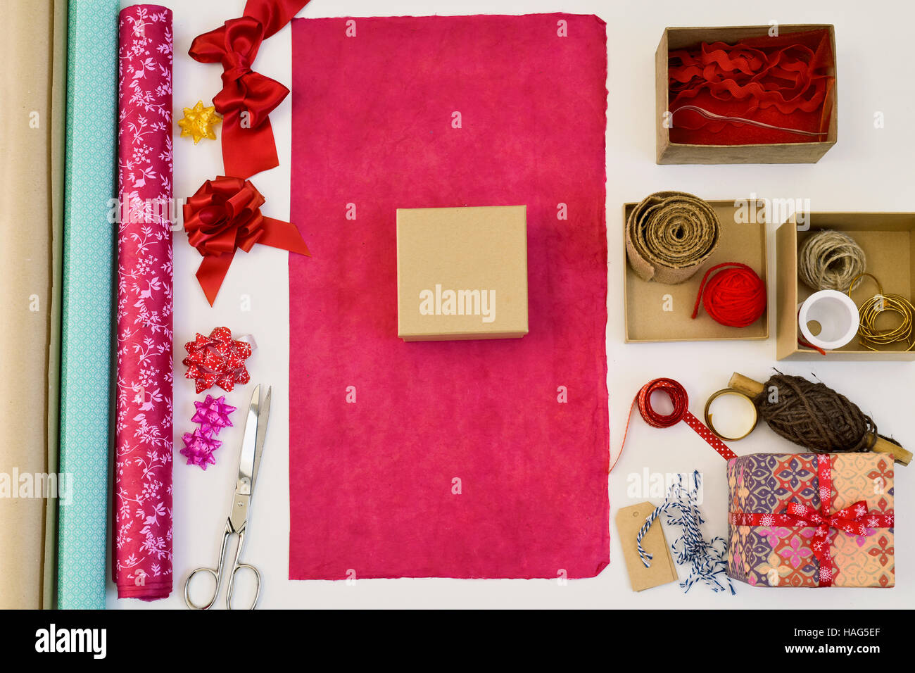high-angle shot of a white table full of boxes, wrapping paper with ...