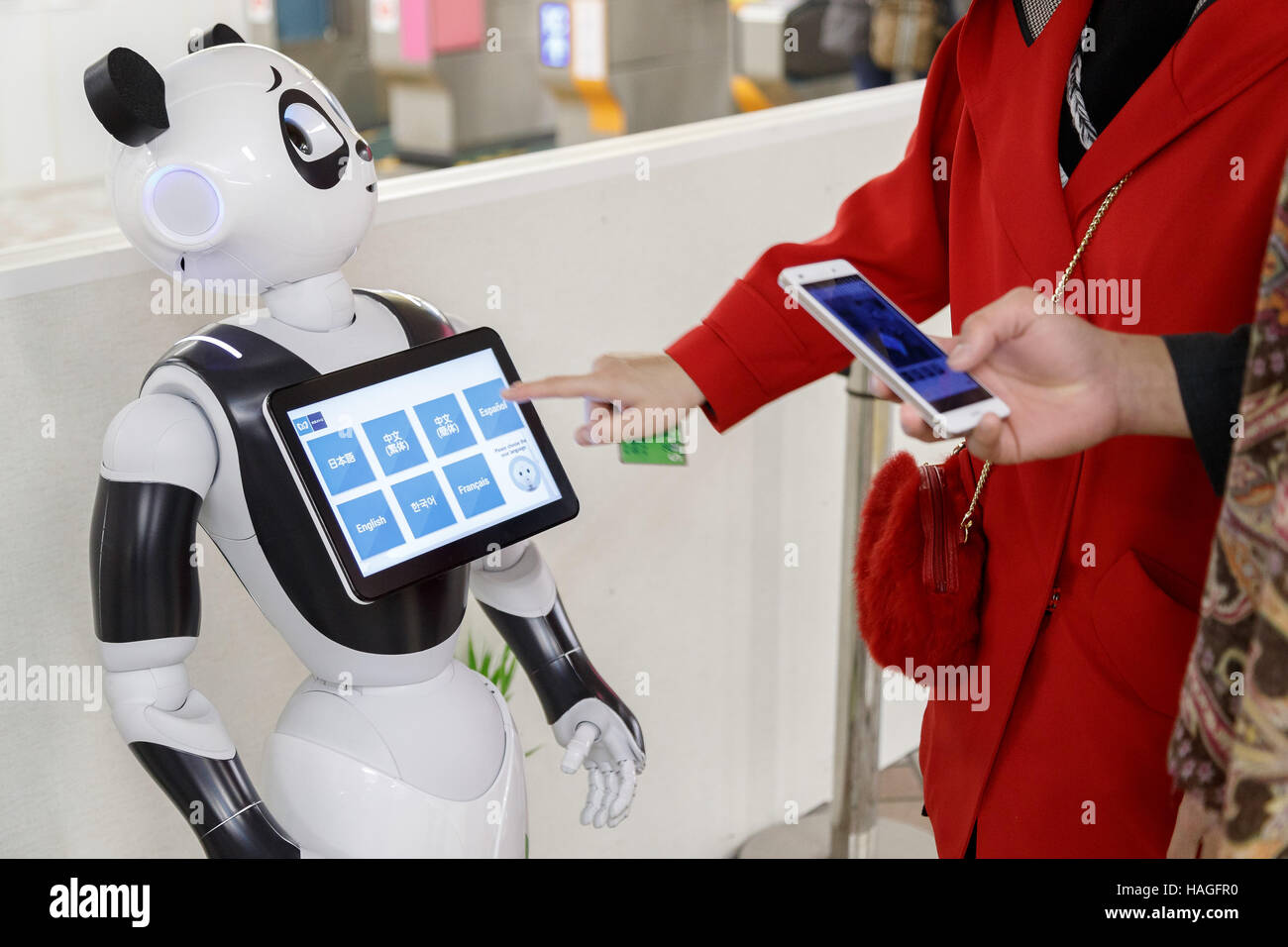 Tokyo, Japan. 1st Dec, 2016. A woman tests a SoftBank's humanoid robot ...