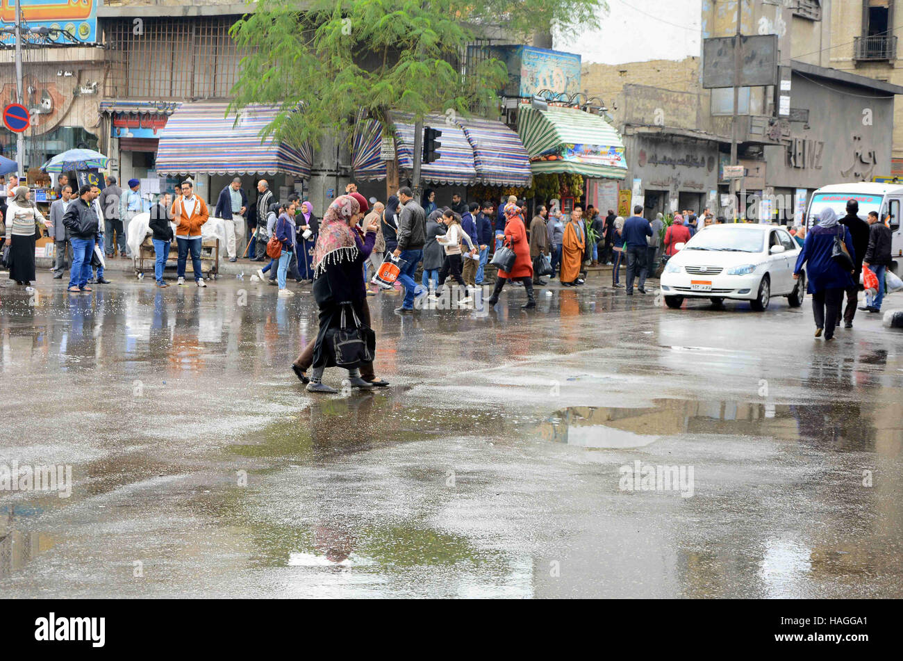 Cairo, Egypt. 12th Dec, 2015. Egyptians walk at street during rain and ...