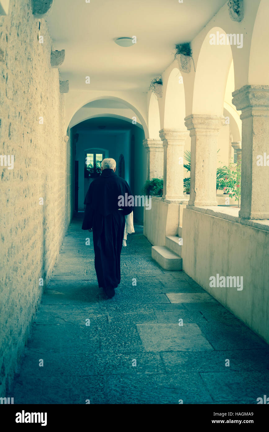 Monk in a monastery atrium Stock Photo - Alamy
