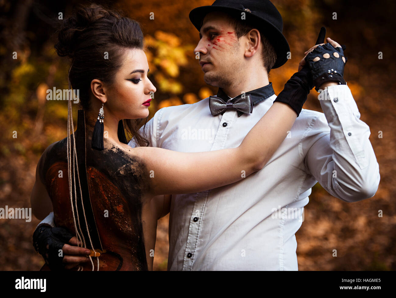 Young man imitating music performance on woman's back with painted ...