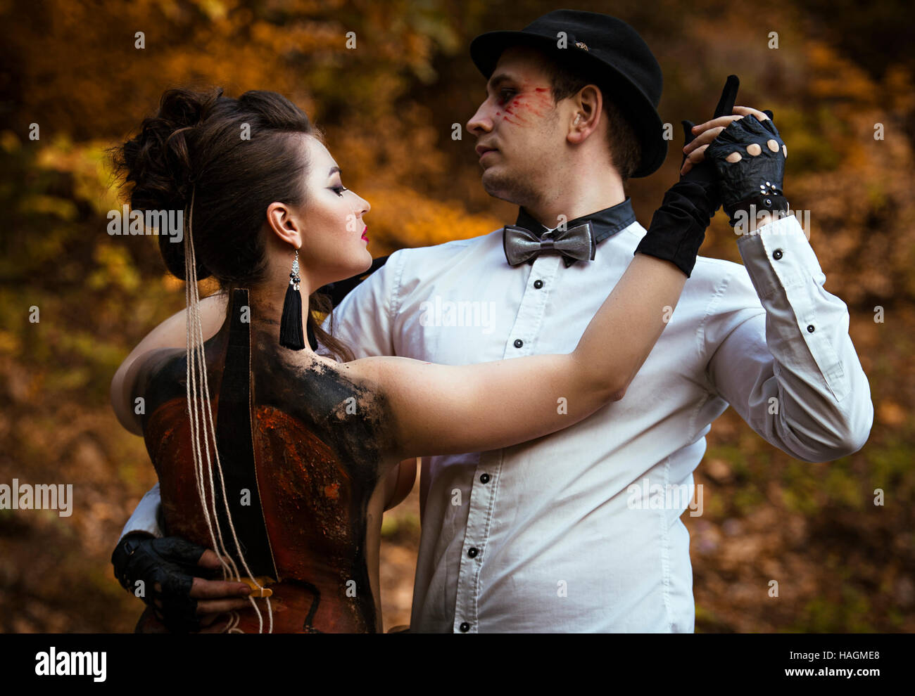 Young man imitating music performance on woman's back with painted ...
