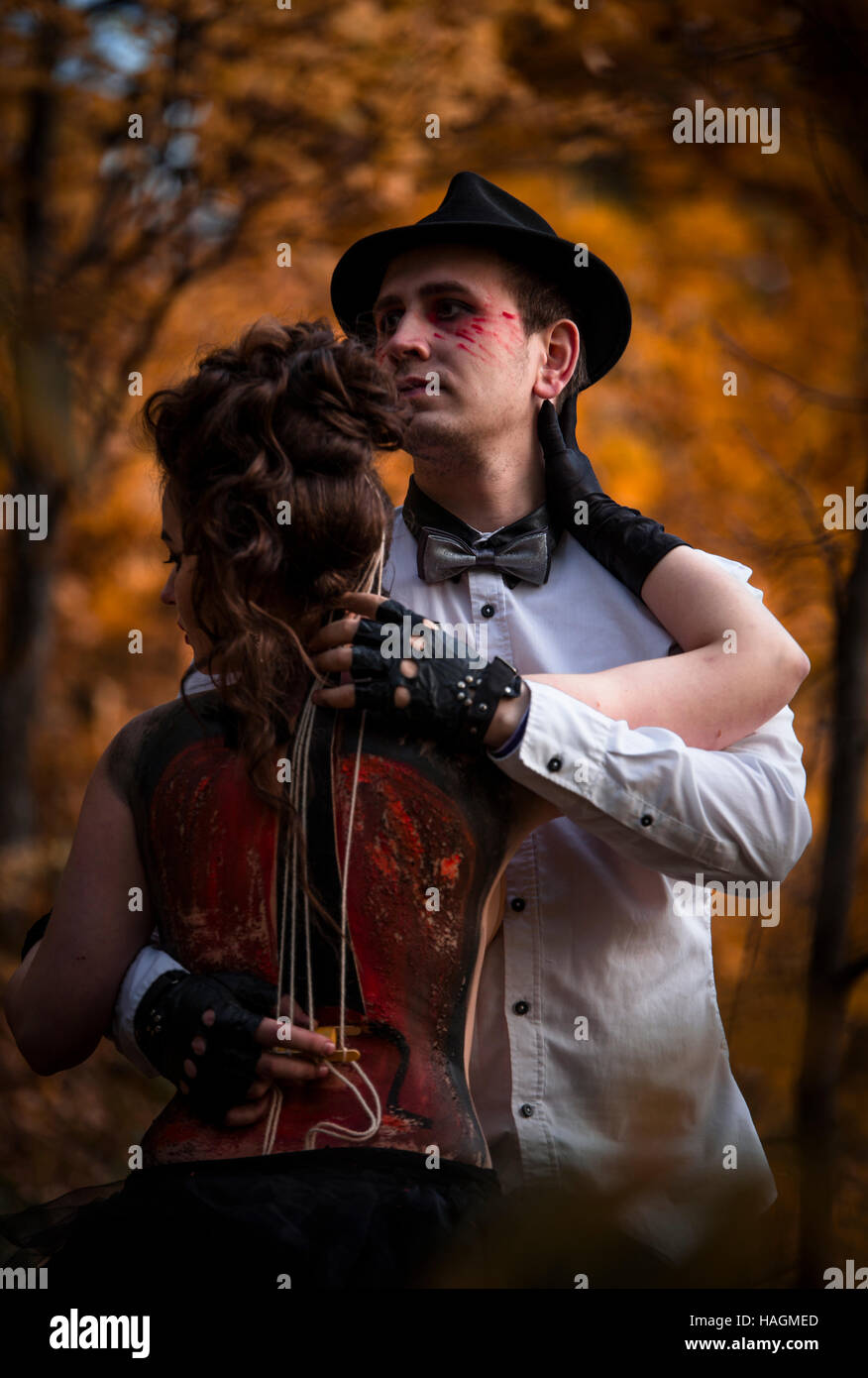 Young man imitating music performance on woman's back with painted ...
