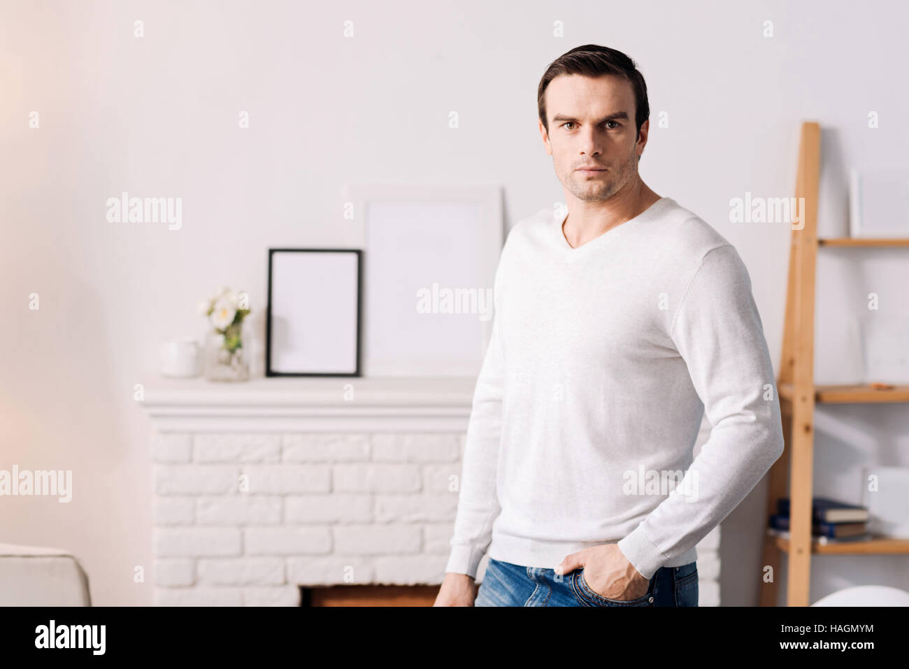 Serious man standign at home Stock Photo - Alamy