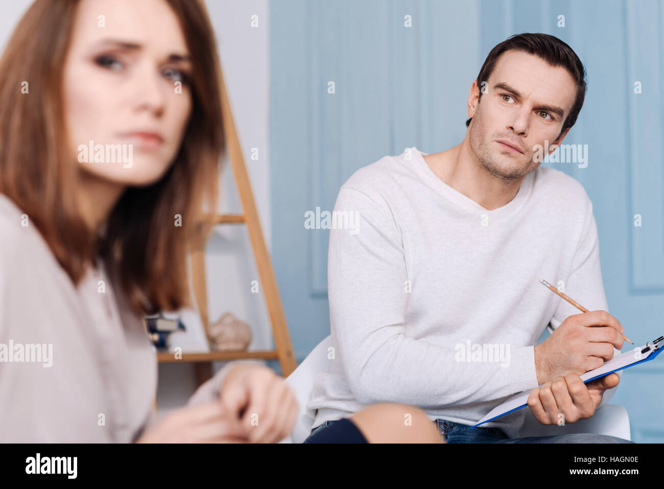 Professional psychologist consulting his client Stock Photo - Alamy