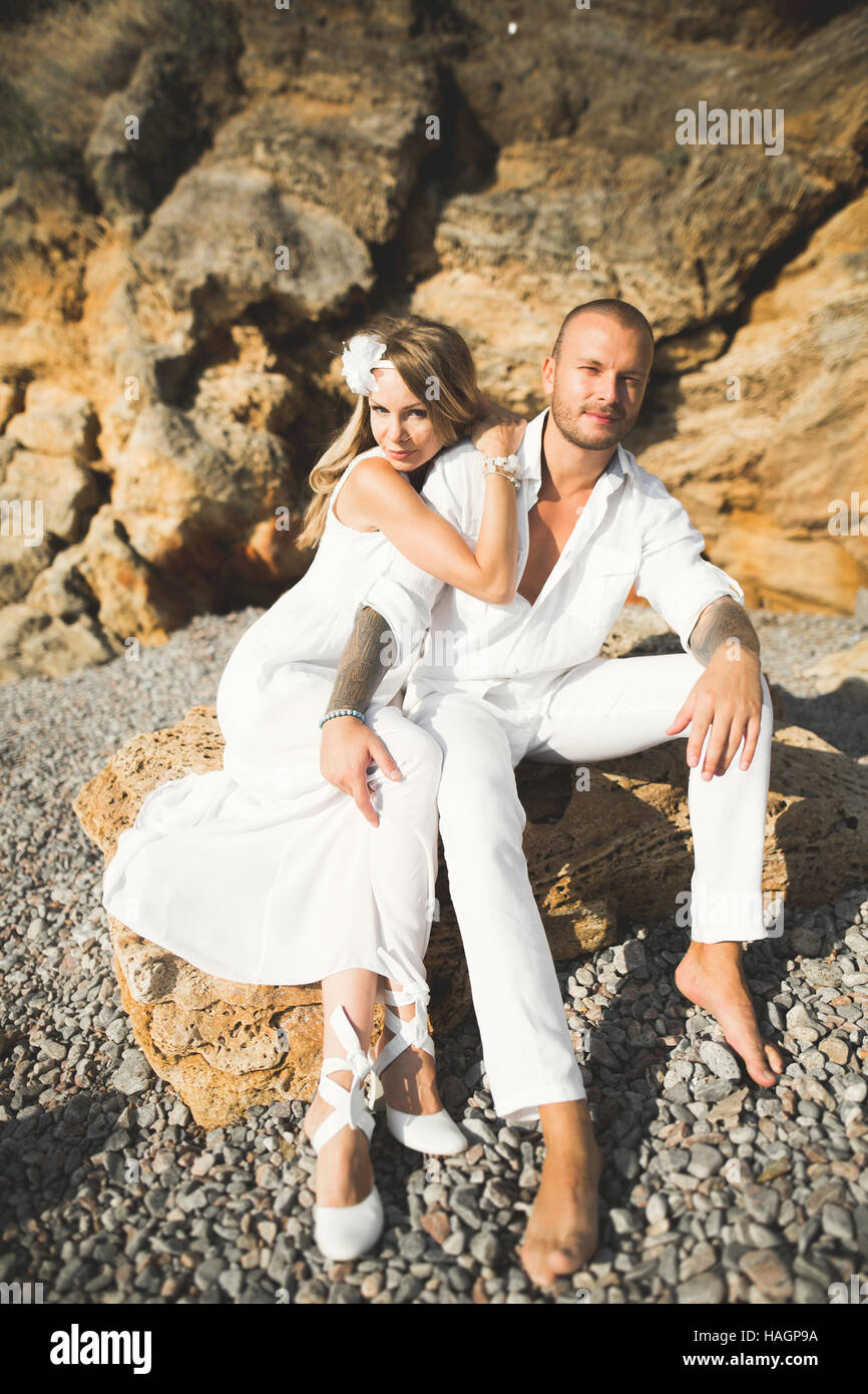 Fashion model couple with tattoo posing outside nea sea Stock Photo - Alamy
