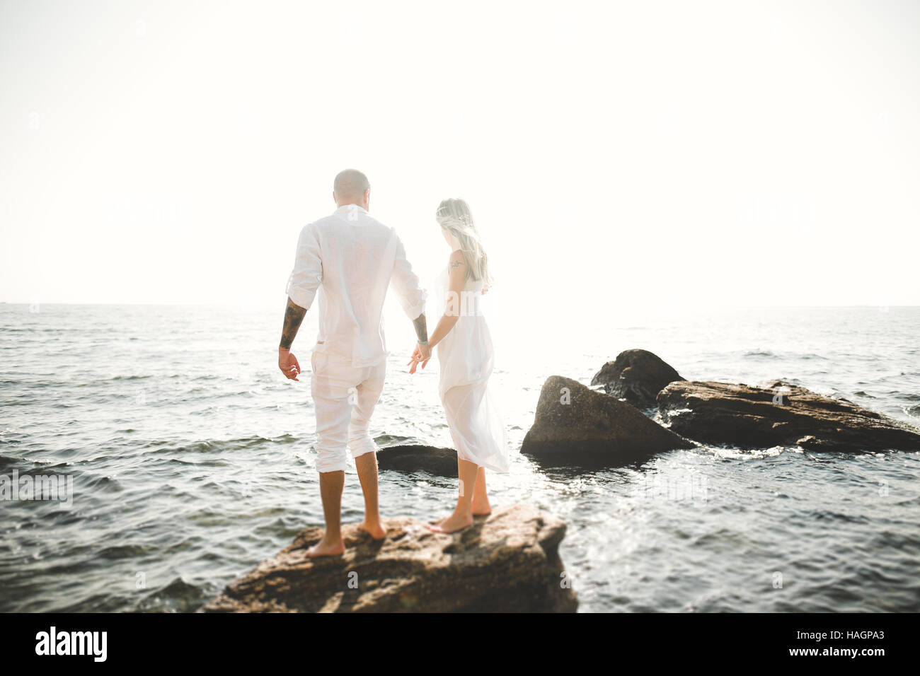 Fashion model couple with tattoo posing outside nea sea Stock Photo - Alamy