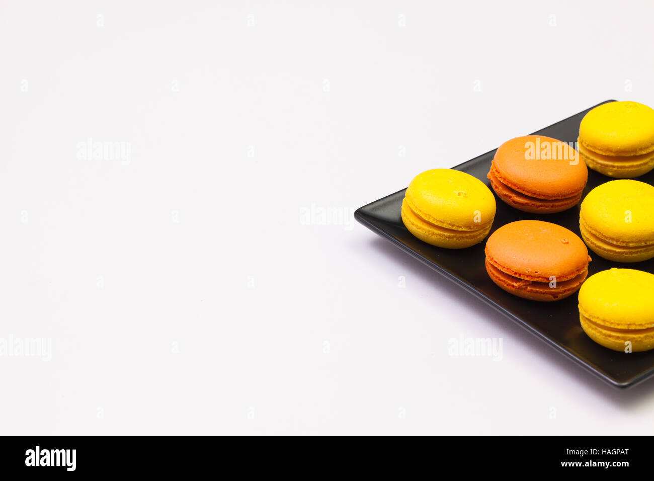 Traditional french colorful macarons on the black plate Stock Photo - Alamy