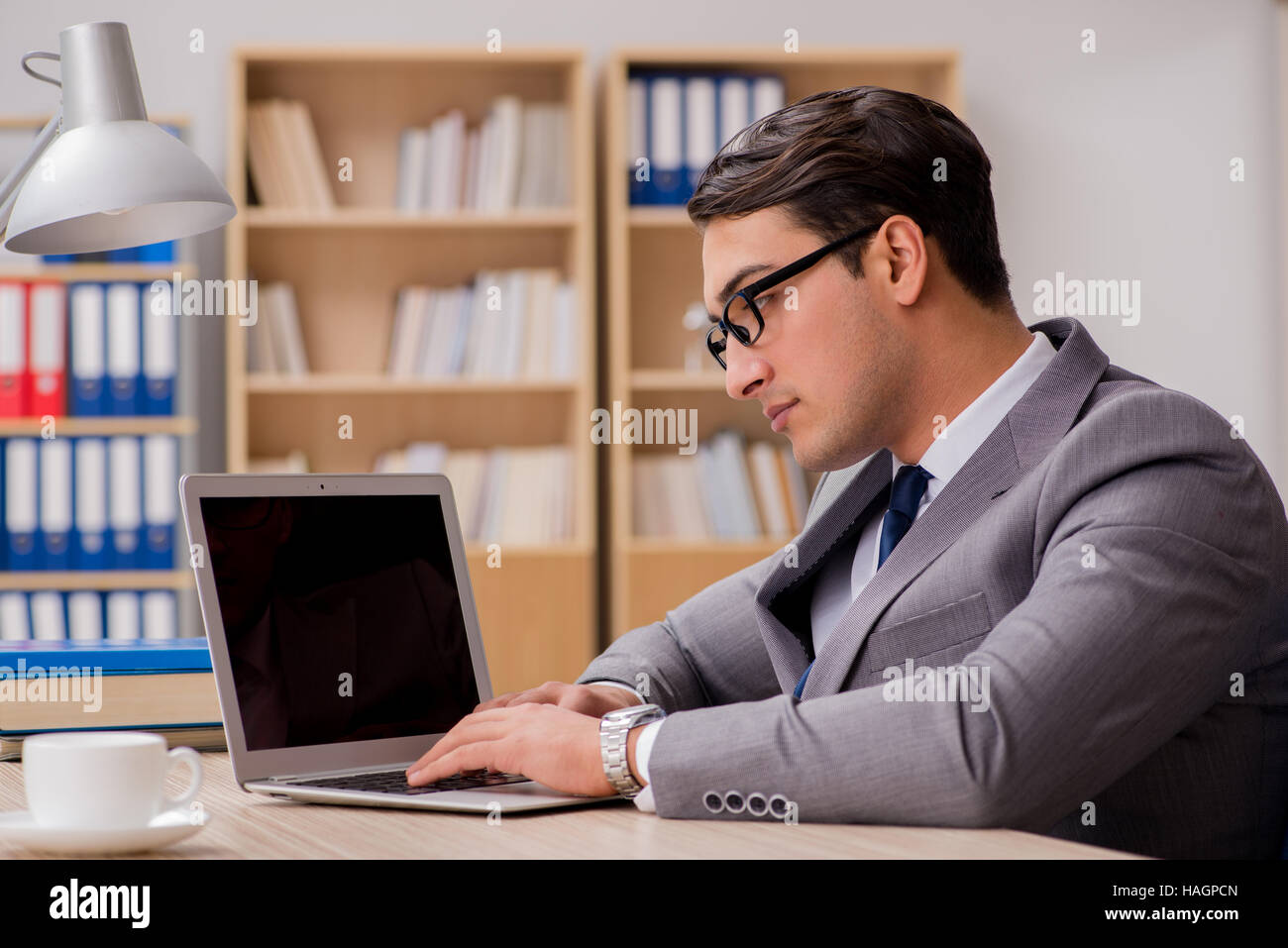 Young handsome businessman working on office Stock Photo - Alamy