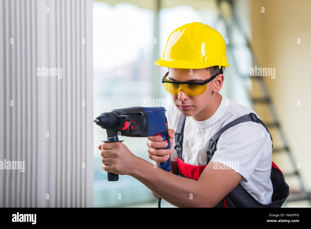Man drilling the wall with drill perforator Stock Photo - Alamy