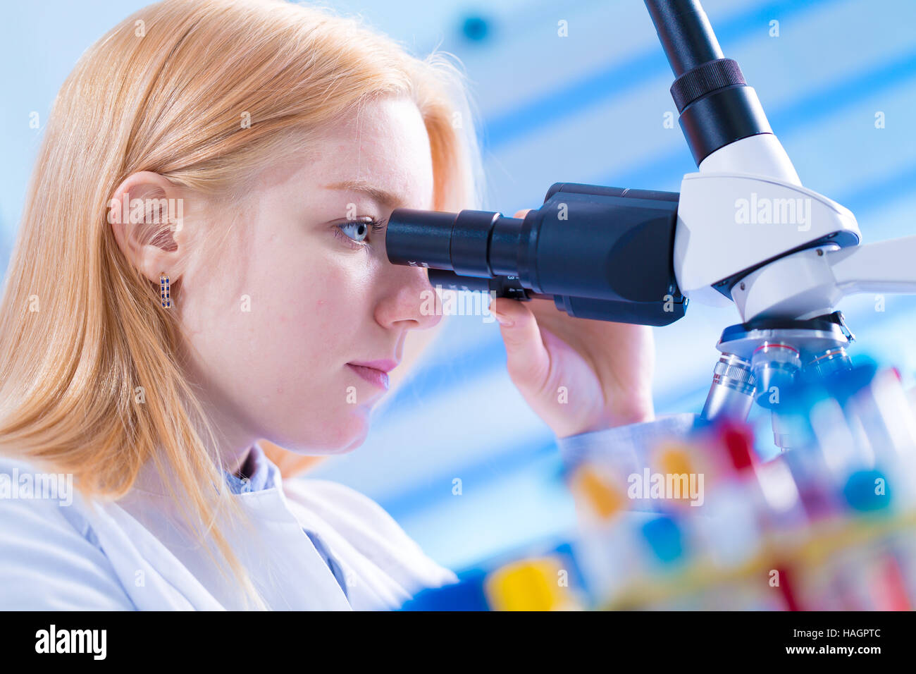 Young woman technician use microscope in laboratory Stock Photo - Alamy