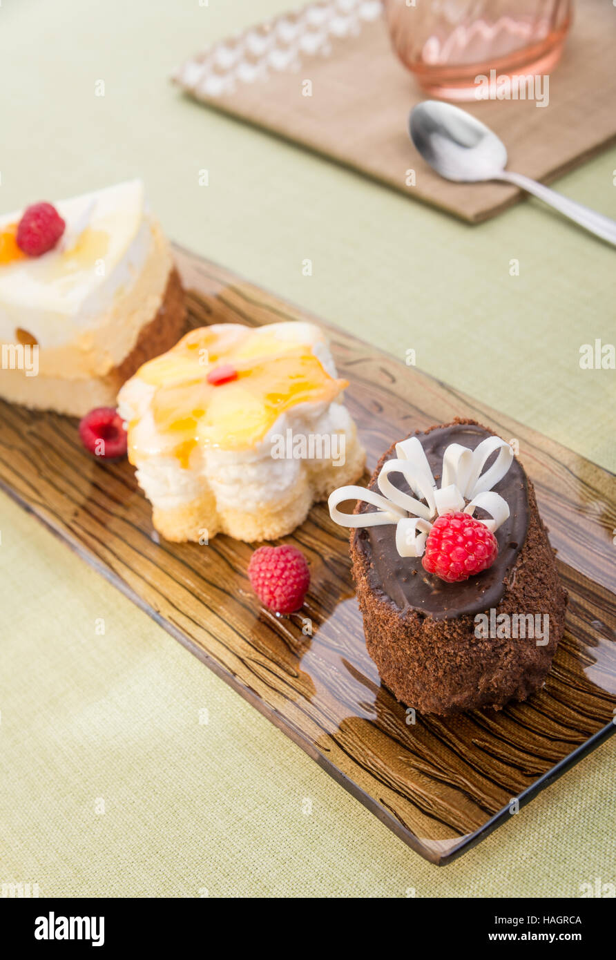 Group of colorful cakes on plate Stock Photo - Alamy
