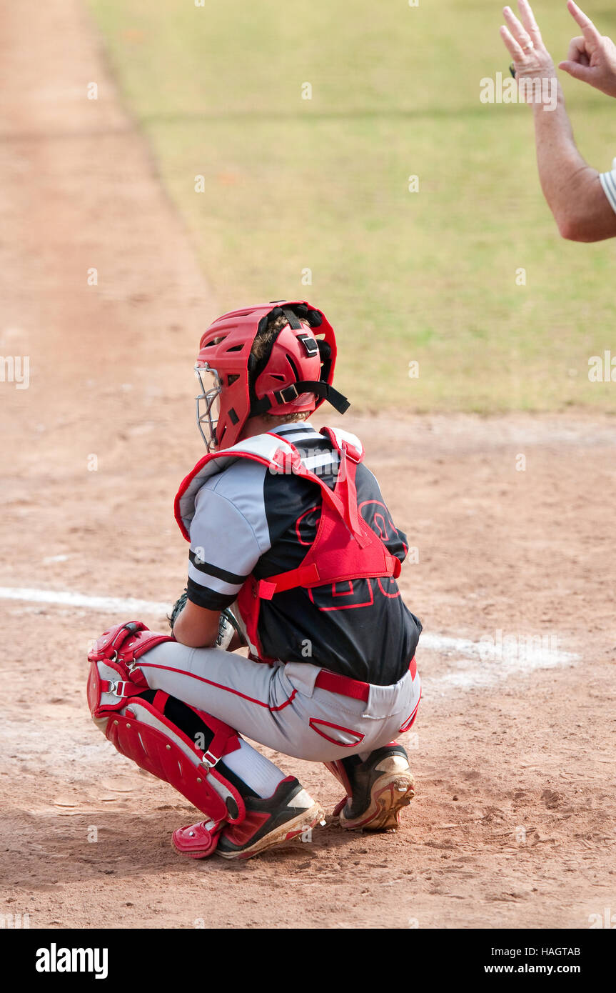 American baseball catcher in black and grey jersey with umpire giving ...