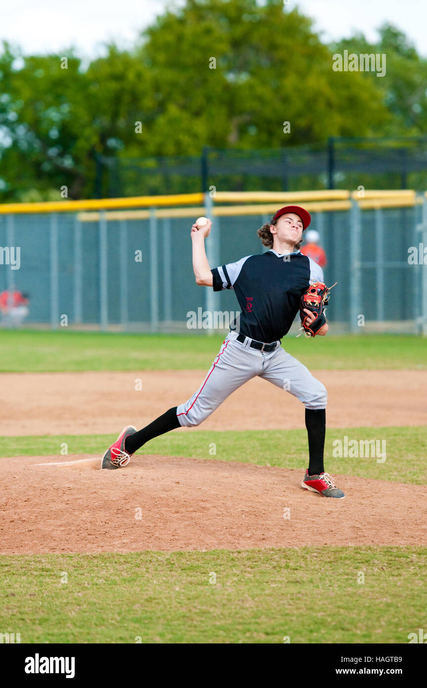 Young teen boy on the pitching mound during wind up Stock Photo - Alamy