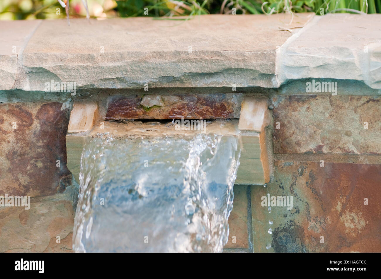 Beautiful poolside waterfall with flagstone Stock Photo - Alamy