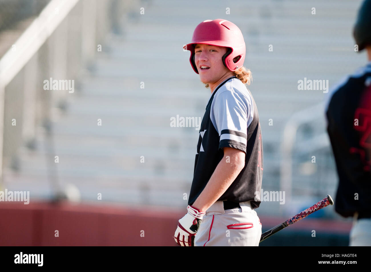Baseball player in black and grey jersey looking back while batting ...