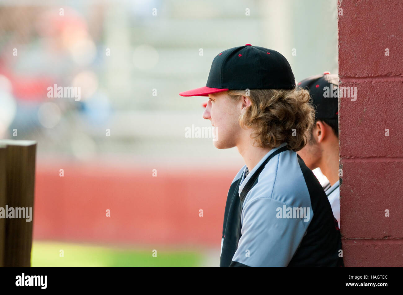 Side profile of baseball player smiling during a game Stock Photo - Alamy