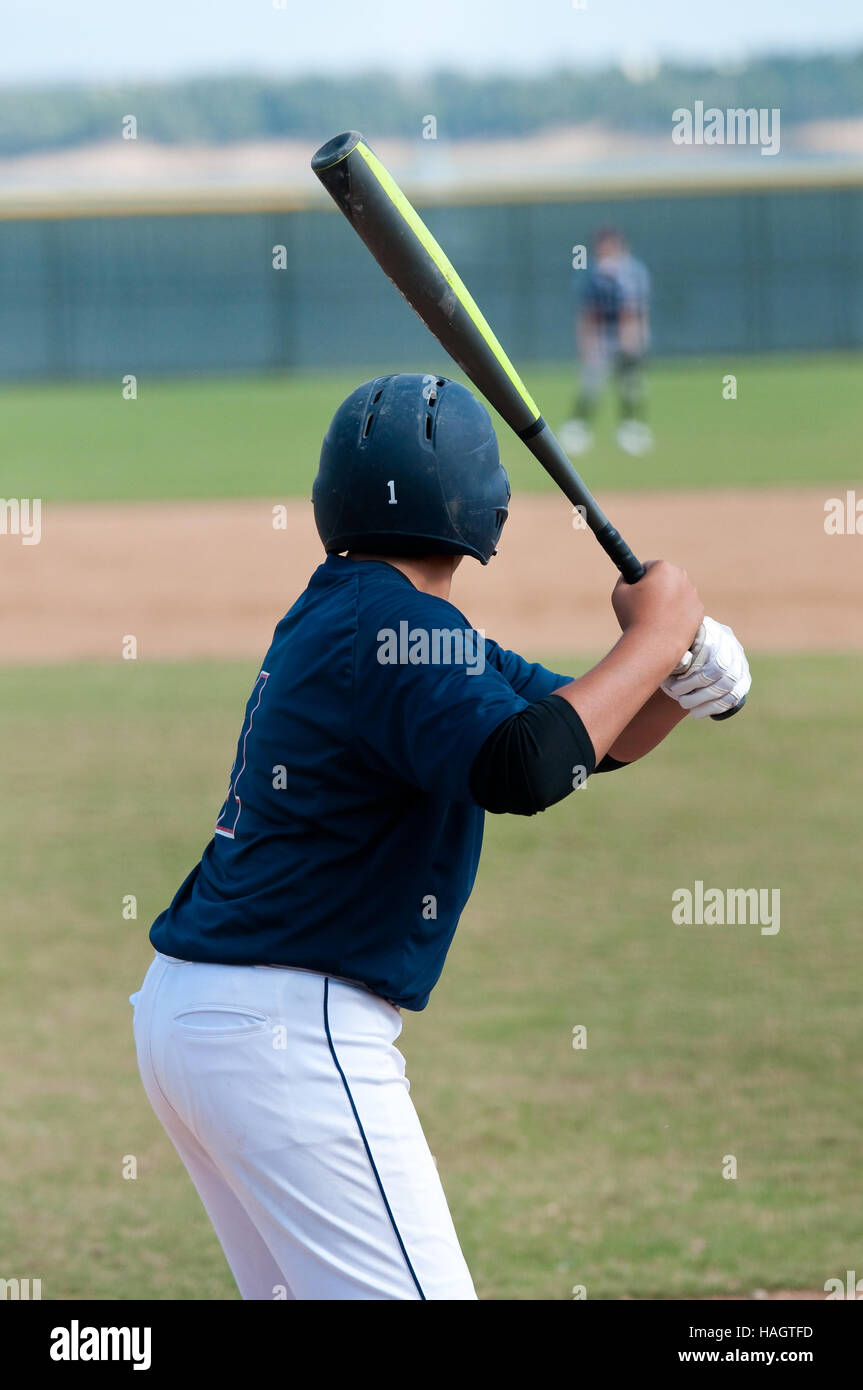 Youth baseball player up at bat in blue jersey Stock Photo - Alamy