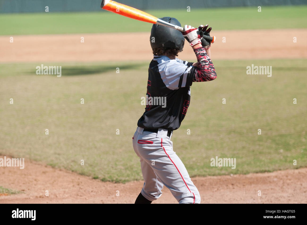 Teenage boy standing at home play ready to bat Stock Photo - Alamy