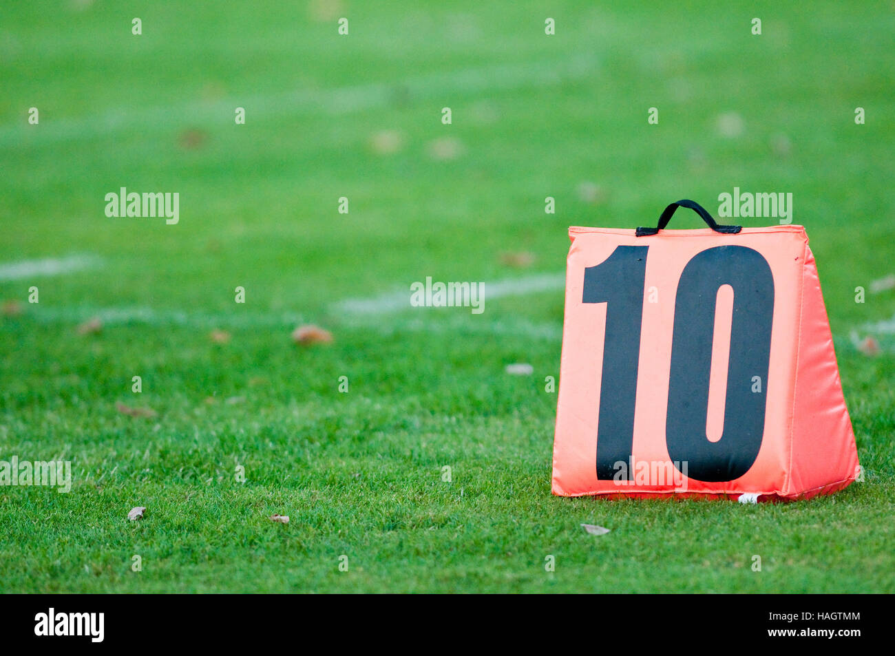 Orange football marker with number 10 Stock Photo - Alamy