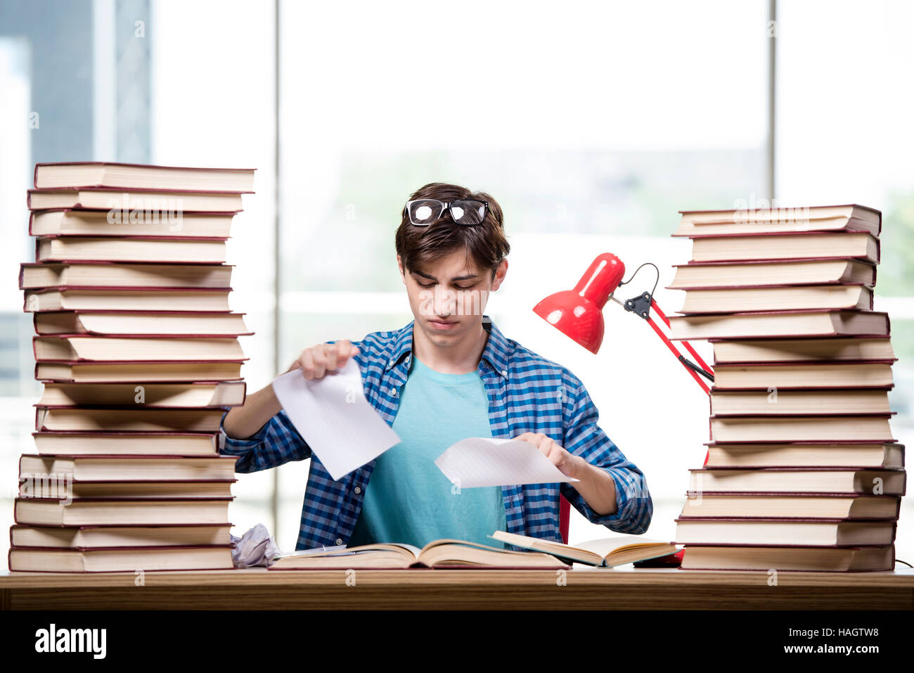 Student with lots of books preparing for exams Stock Photo - Alamy