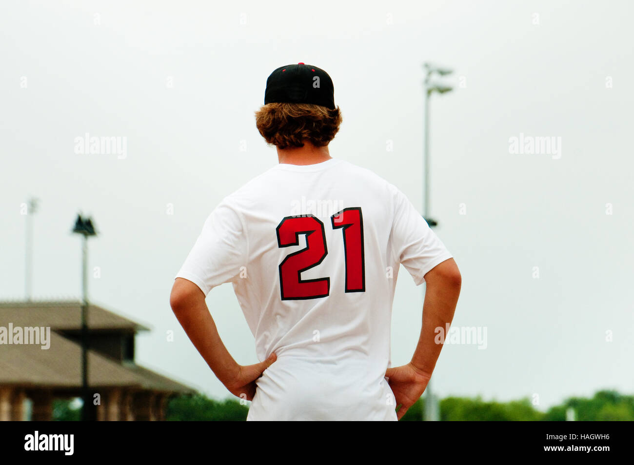 Baseball player from behind with hands on hip Stock Photo - Alamy