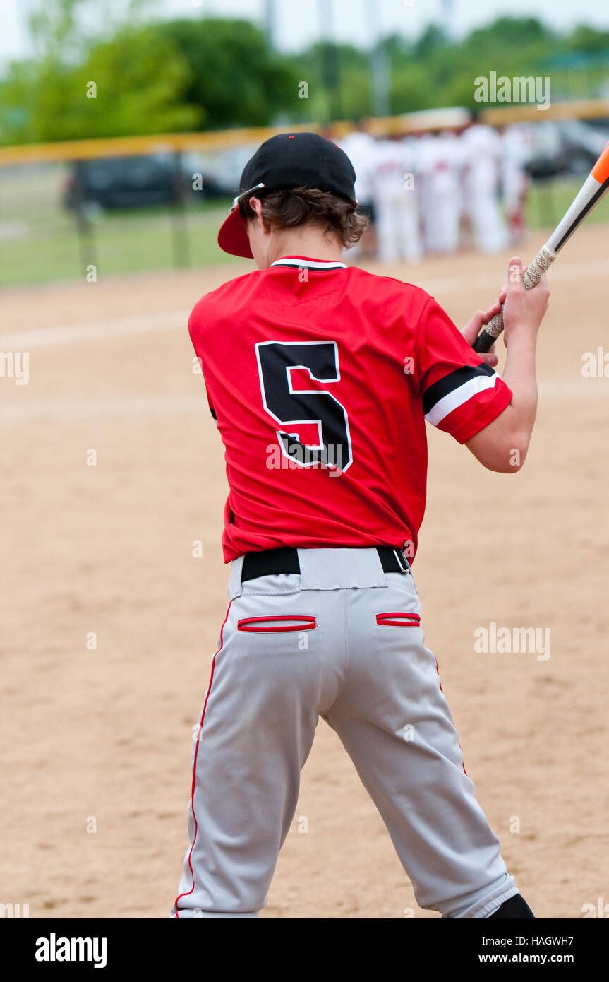 American baseball player holding bat during a game Stock Photo - Alamy