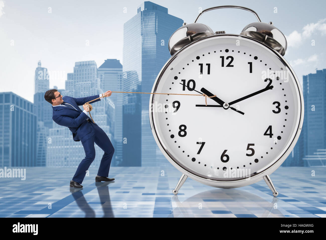 Businessman pulling clock in time management concept Stock Photo - Alamy