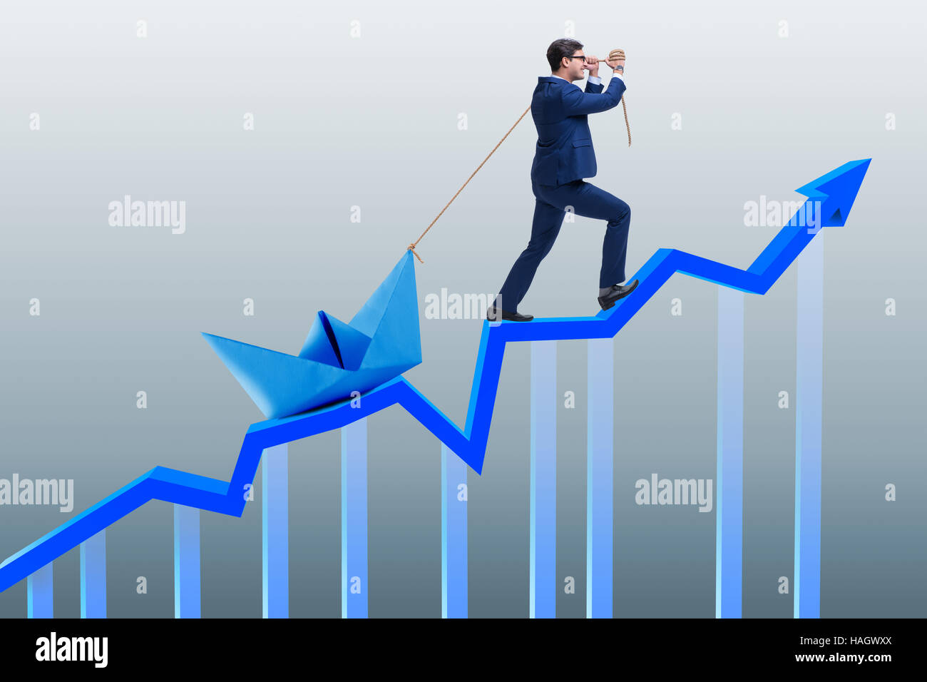 Businessman pulling boat over line chart Stock Photo - Alamy