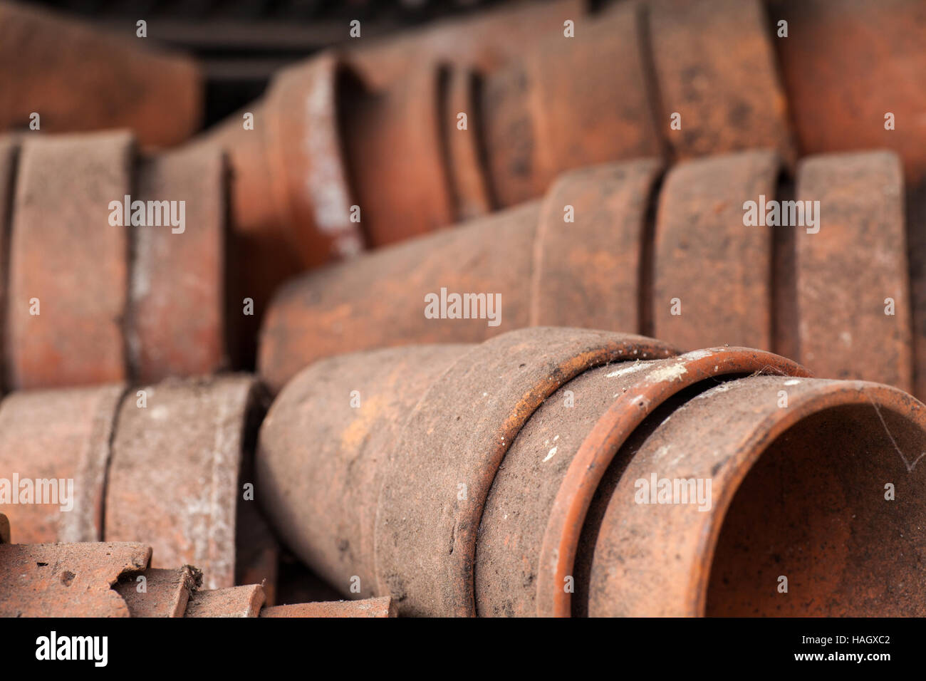 A stack of used clay pots in the garden Stock Photo - Alamy