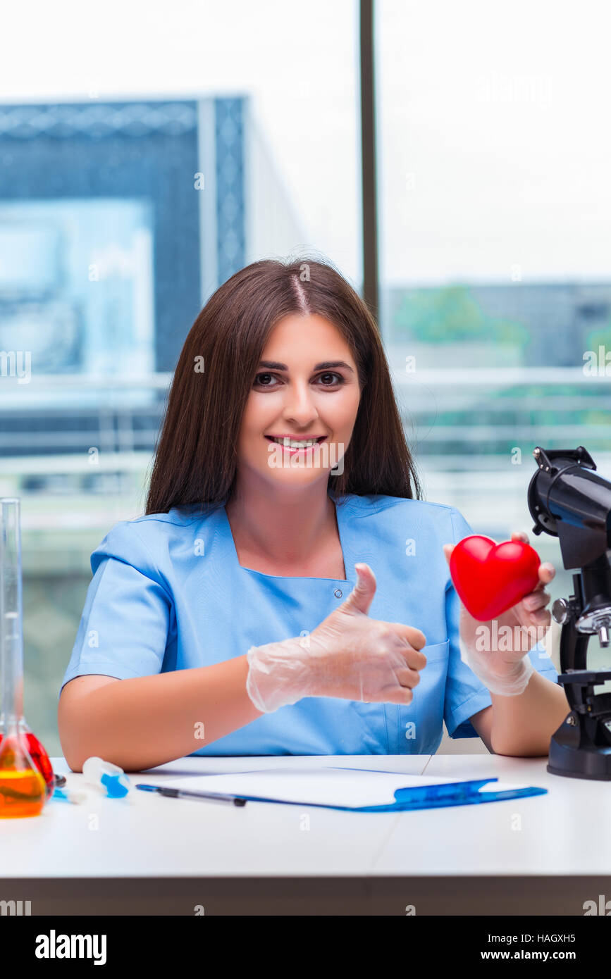 Young doctor with red heart in lab Stock Photo - Alamy