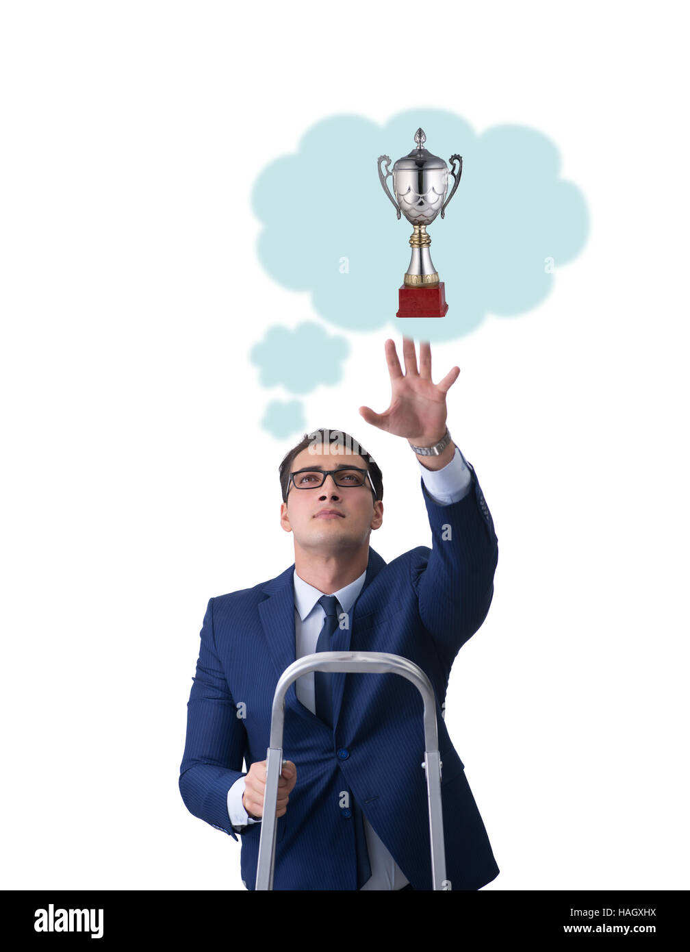 Businessman reaching out for prize cup Stock Photo - Alamy
