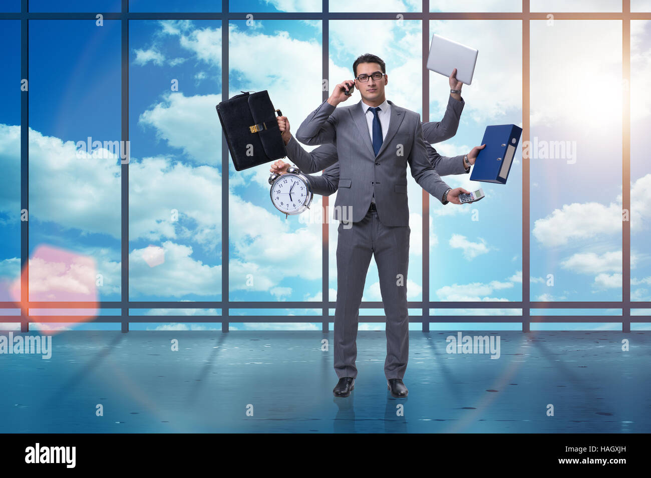 Young businessman in multitasking concept Stock Photo - Alamy