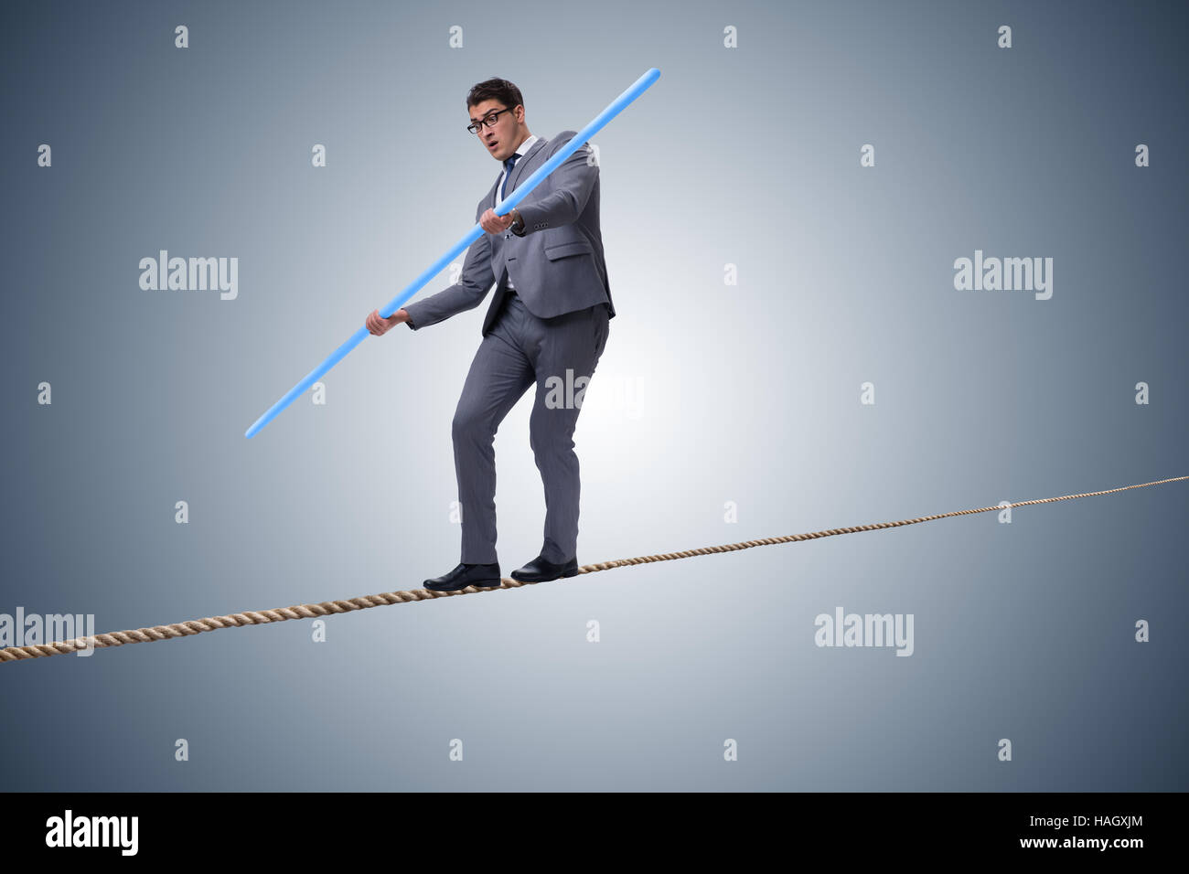 Businessman doing tightrope walking in risk concept Stock Photo - Alamy
