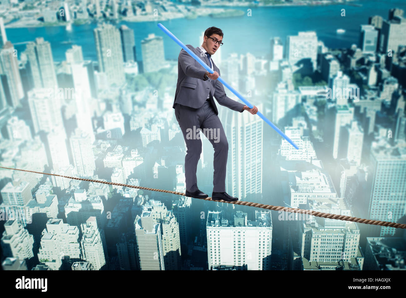 Businessman doing tightrope walking in risk concept Stock Photo - Alamy