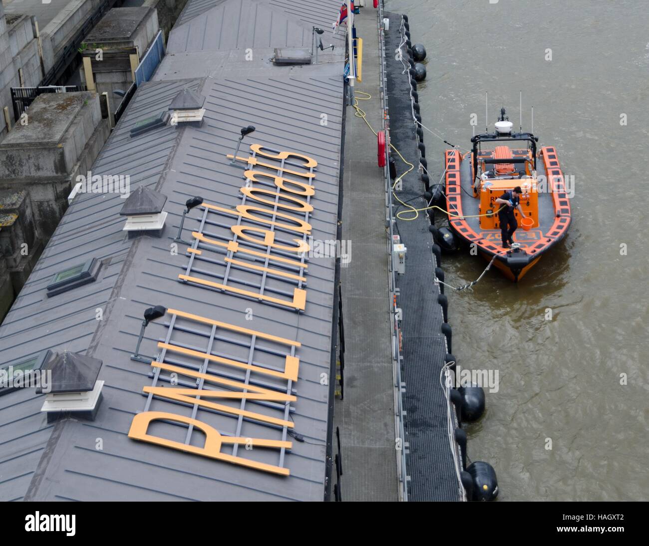 A RNLI worker prepares to maintain his boat on the Thames river, London ...