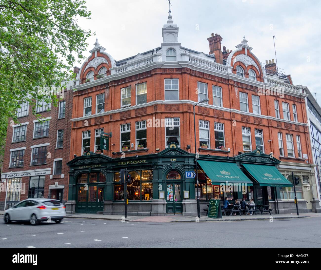 People enjoy a meal at the Peasant Gastropub in Clerkenwell, London ...