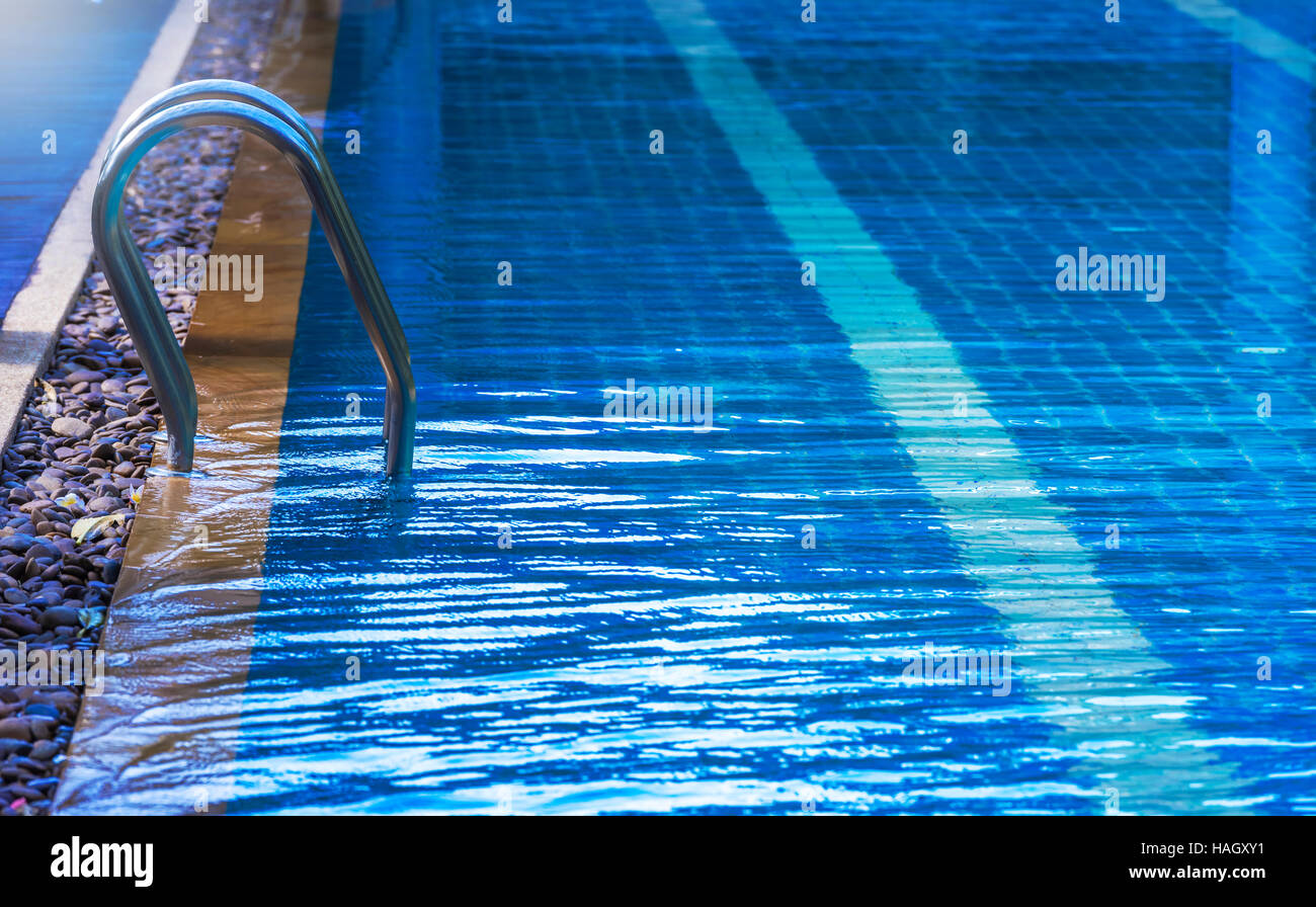 Swimming pool with stair under sun light Stock Photo - Alamy