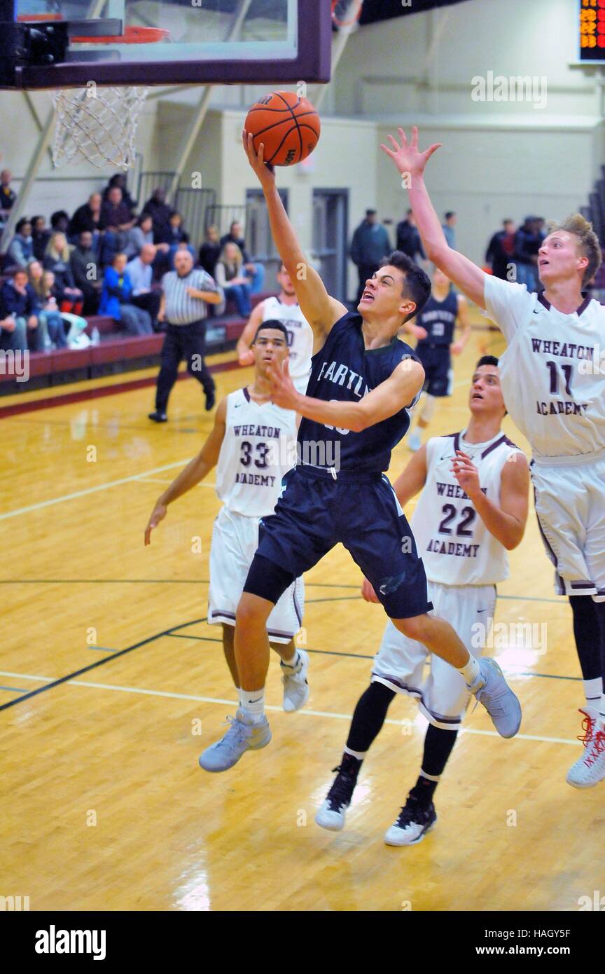 Taking advantage of an inside position, a player attempts a layup off ...