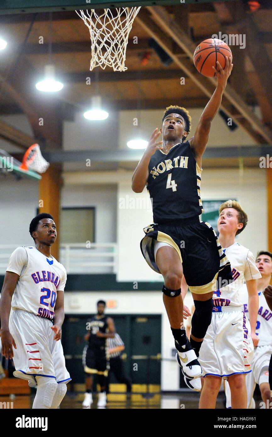 Player completing an uncontested layup after leaving floor-bound ...