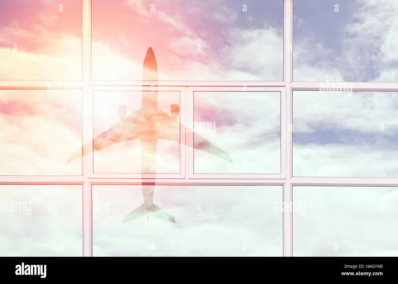 The shadow of the airplane on glass window of the building with the ...