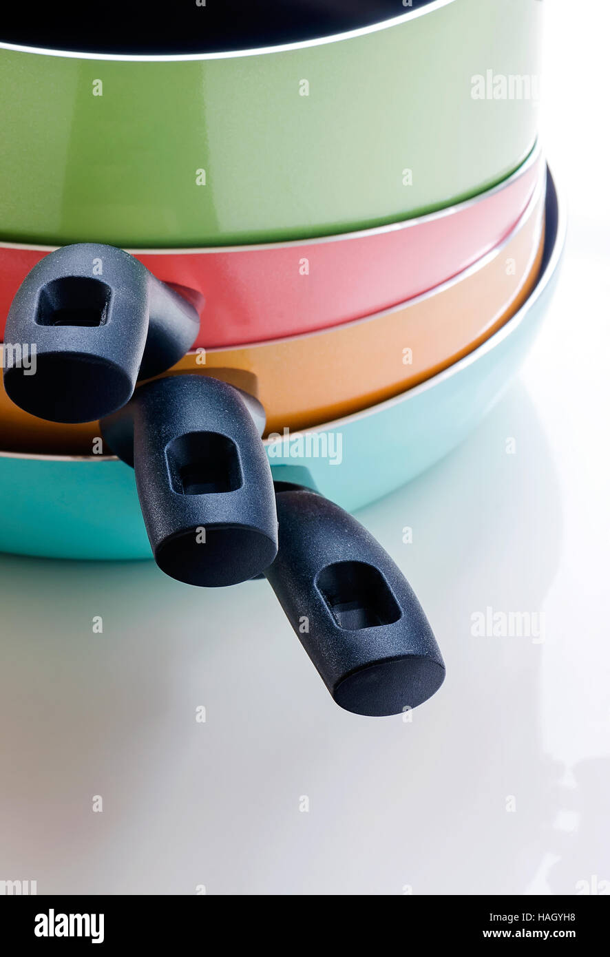 stack of colorful cooking pans on white background,close up view Stock ...