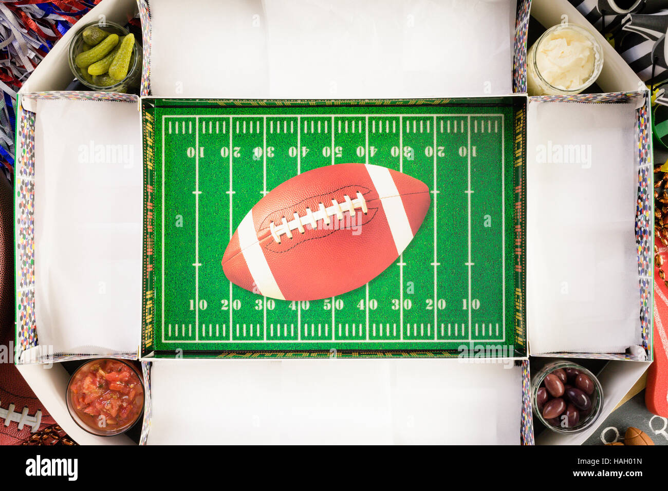 Step by step. Filling in football snack stadium with sub sandwiches ...