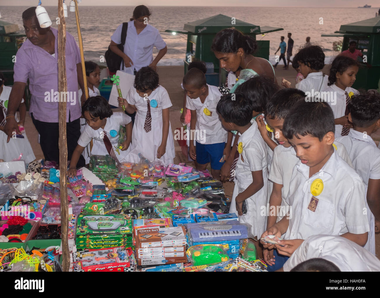 Group of school children looking at toy stall on Galle face Green ...