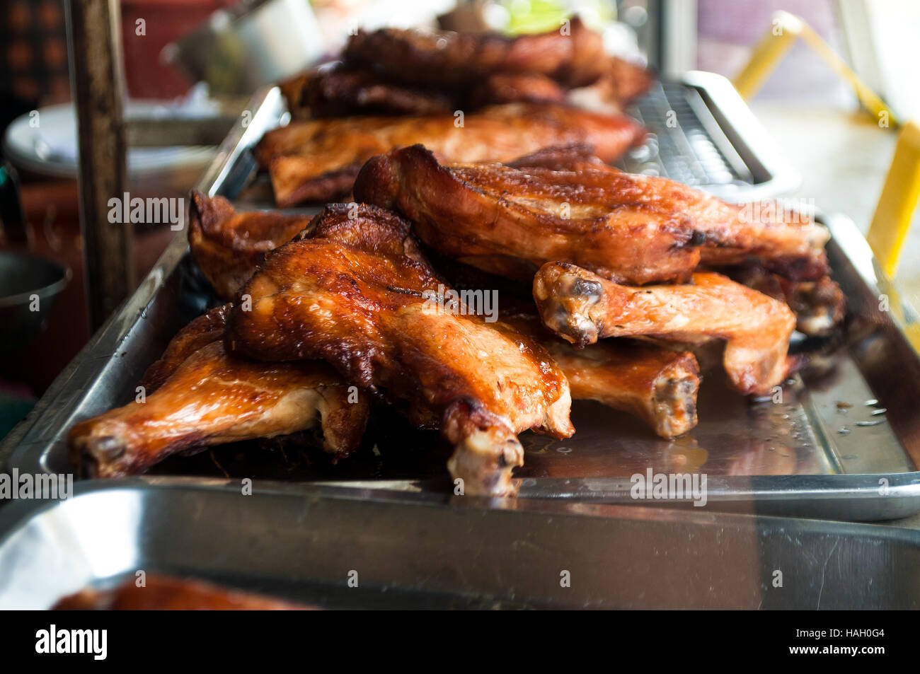 Grilled chicken, Thai style, in a tray on street food stall for sale ...