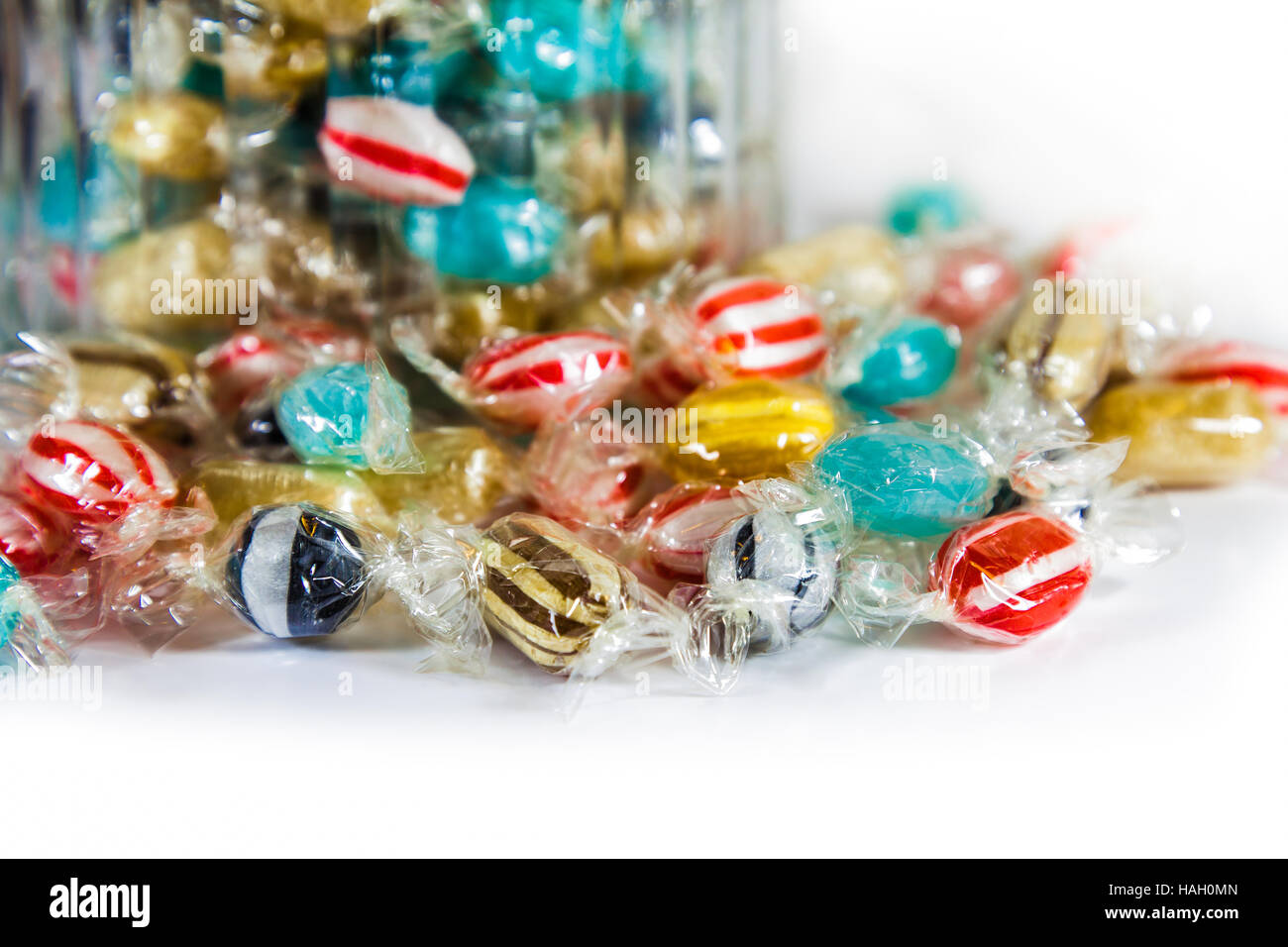 Colorful sweets outside a glass jar Stock Photo - Alamy